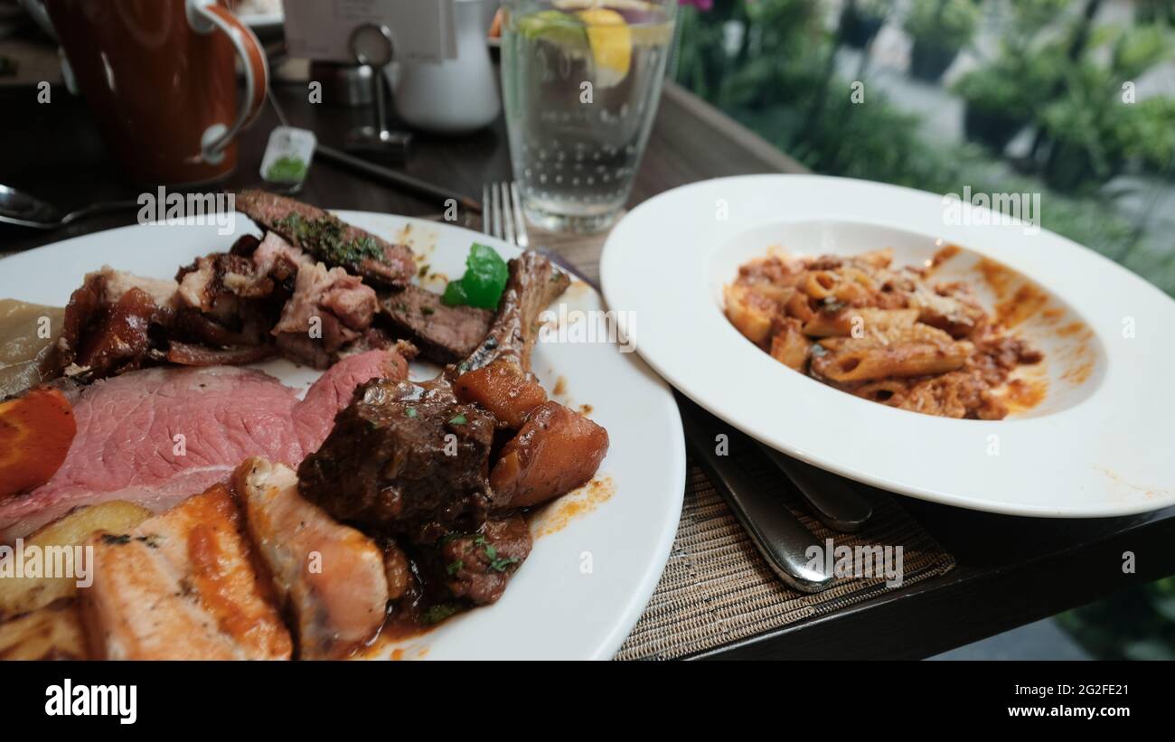 Buffet smorgasbord food on a plate sit down eating out five star casual ...