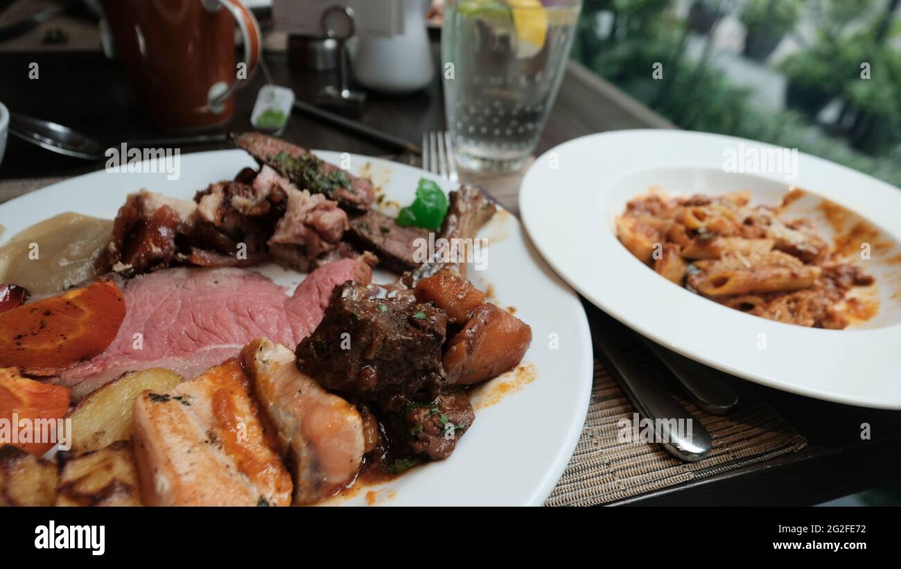 Buffet smorgasbord food on a plate sit down eating out five star casual ...