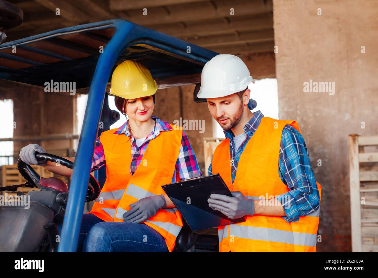 Young professional factory workers discussing working issues Stock ...