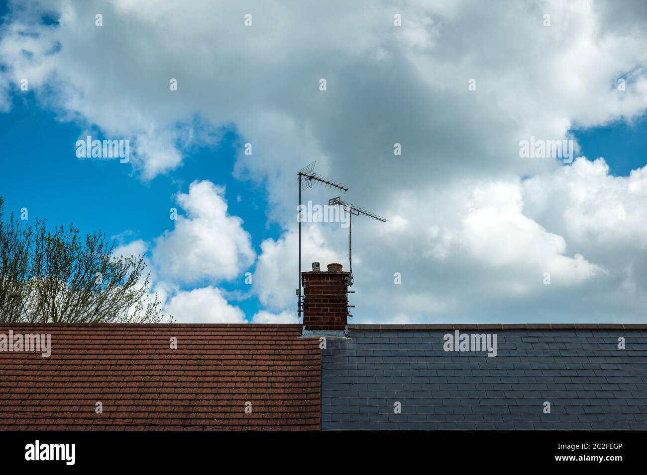 british house roof with chimneys half decorated Stock Photo - Alamy