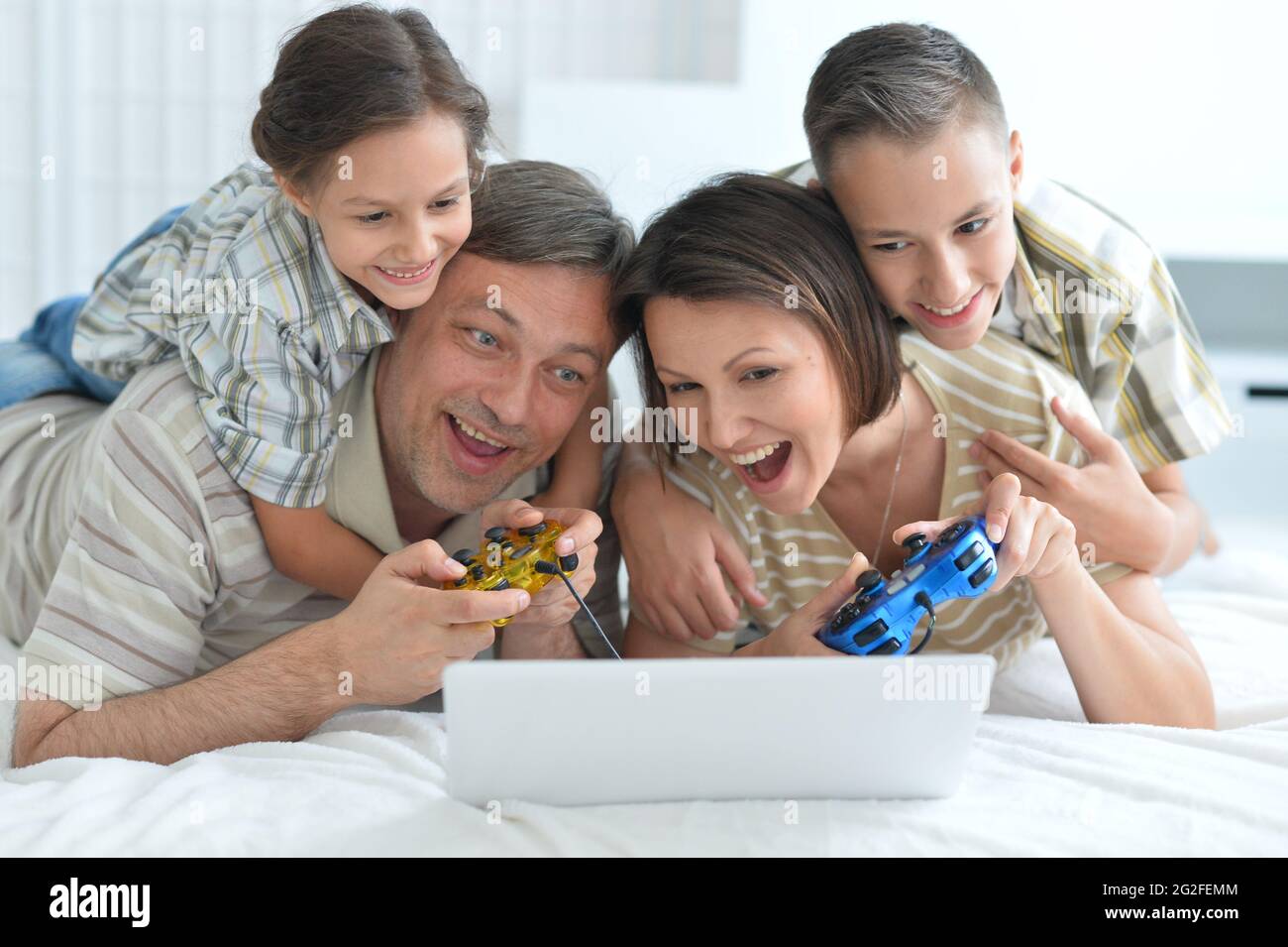 Family playing computer games, parents with kids Stock Photo - Alamy