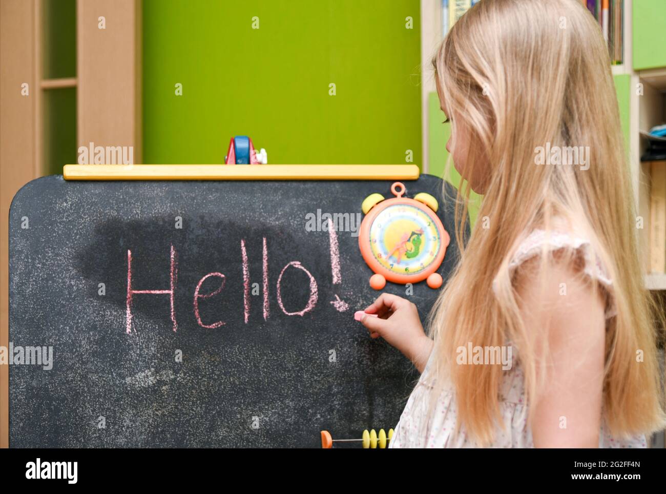 Little girl drawing on blackboard hi-res stock photography and images ...