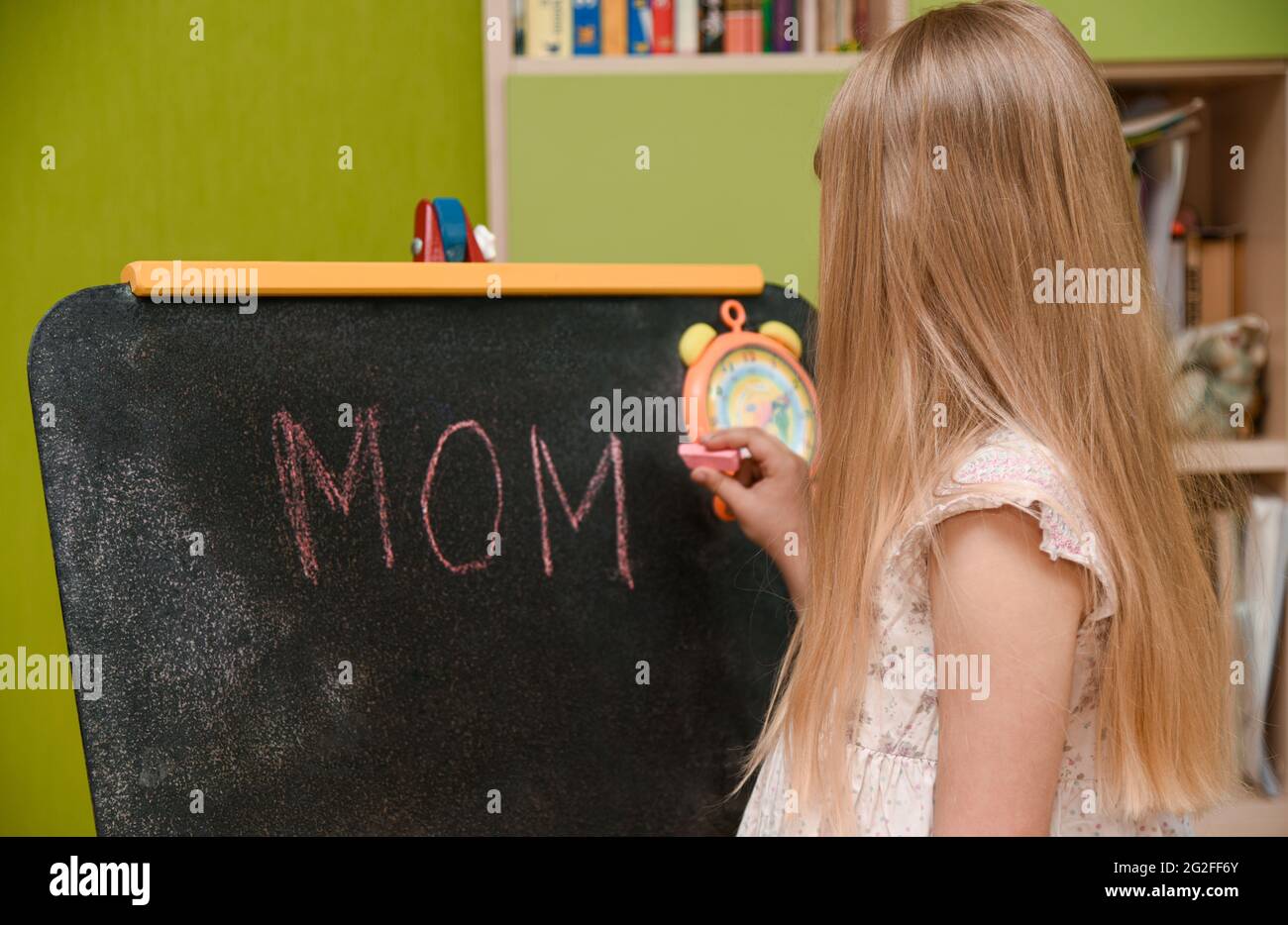 Little girl drawing on blackboard hi-res stock photography and images ...