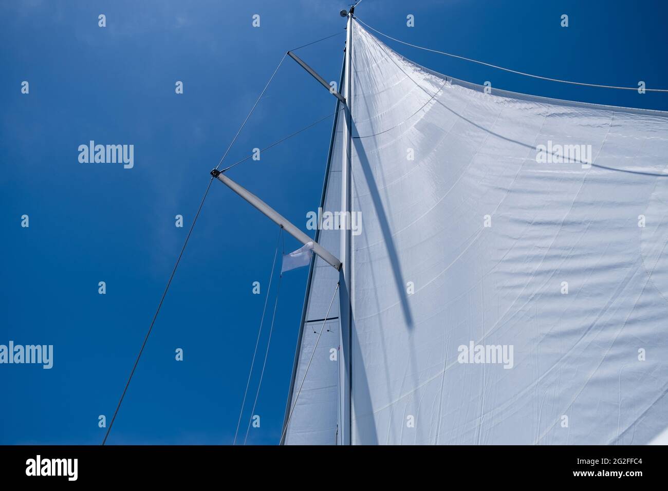 Yacht open sails on clear blue sky background. Sailing with the wind at ...