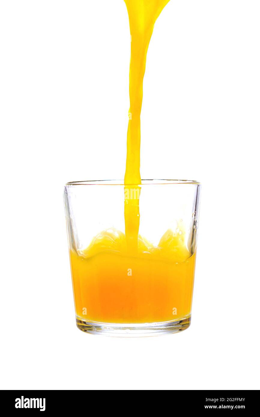 pouring orange juice in glass isolated on white background Stock Photo ...