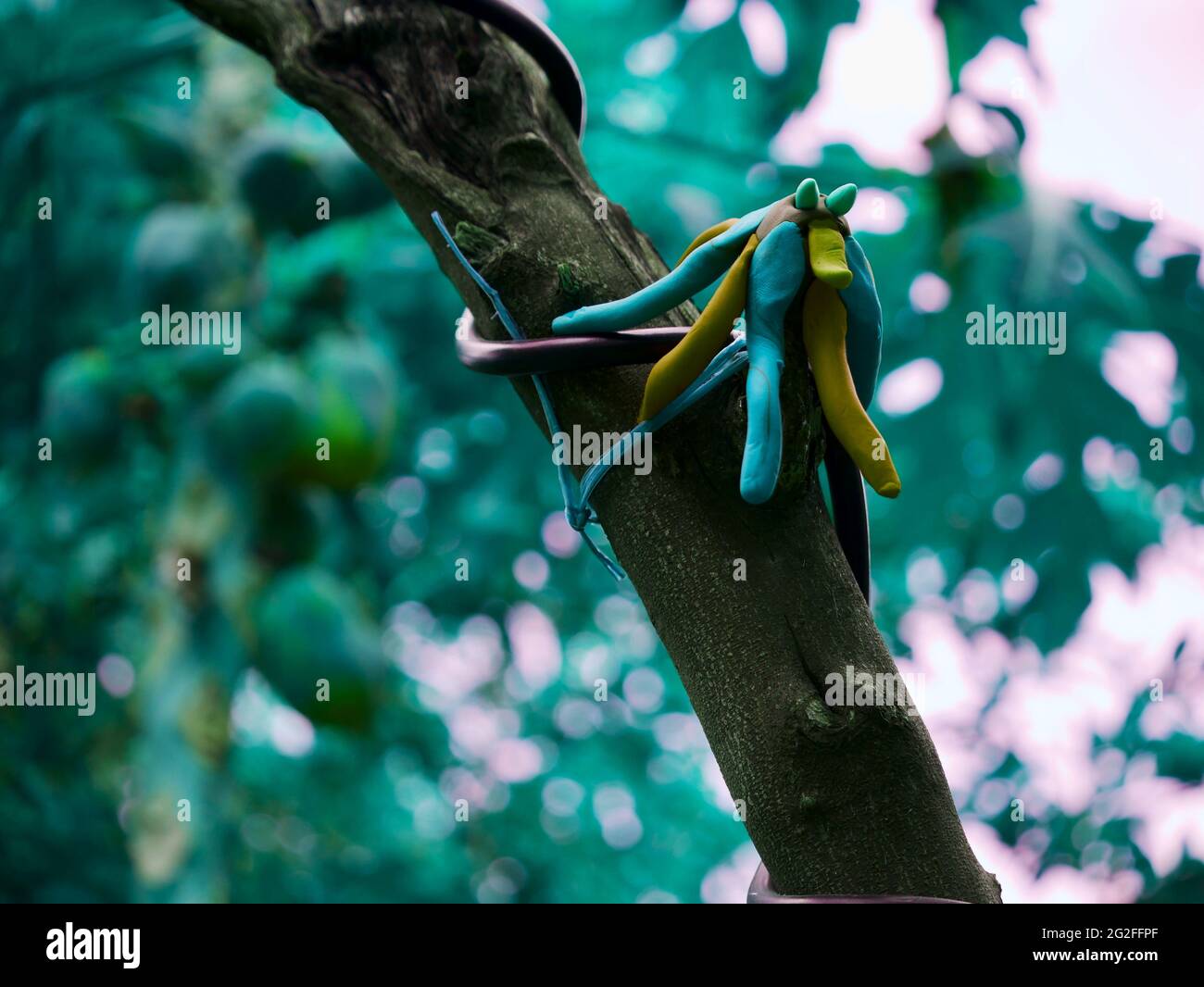 alien creature made with moulded clay art presented in wooden pole ...