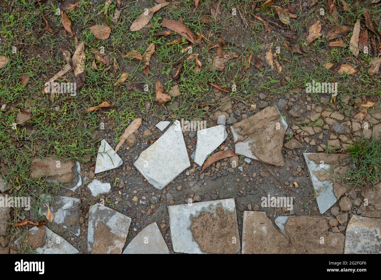 Closeup shot of broken tiles on a dirty floor Stock Photo - Alamy