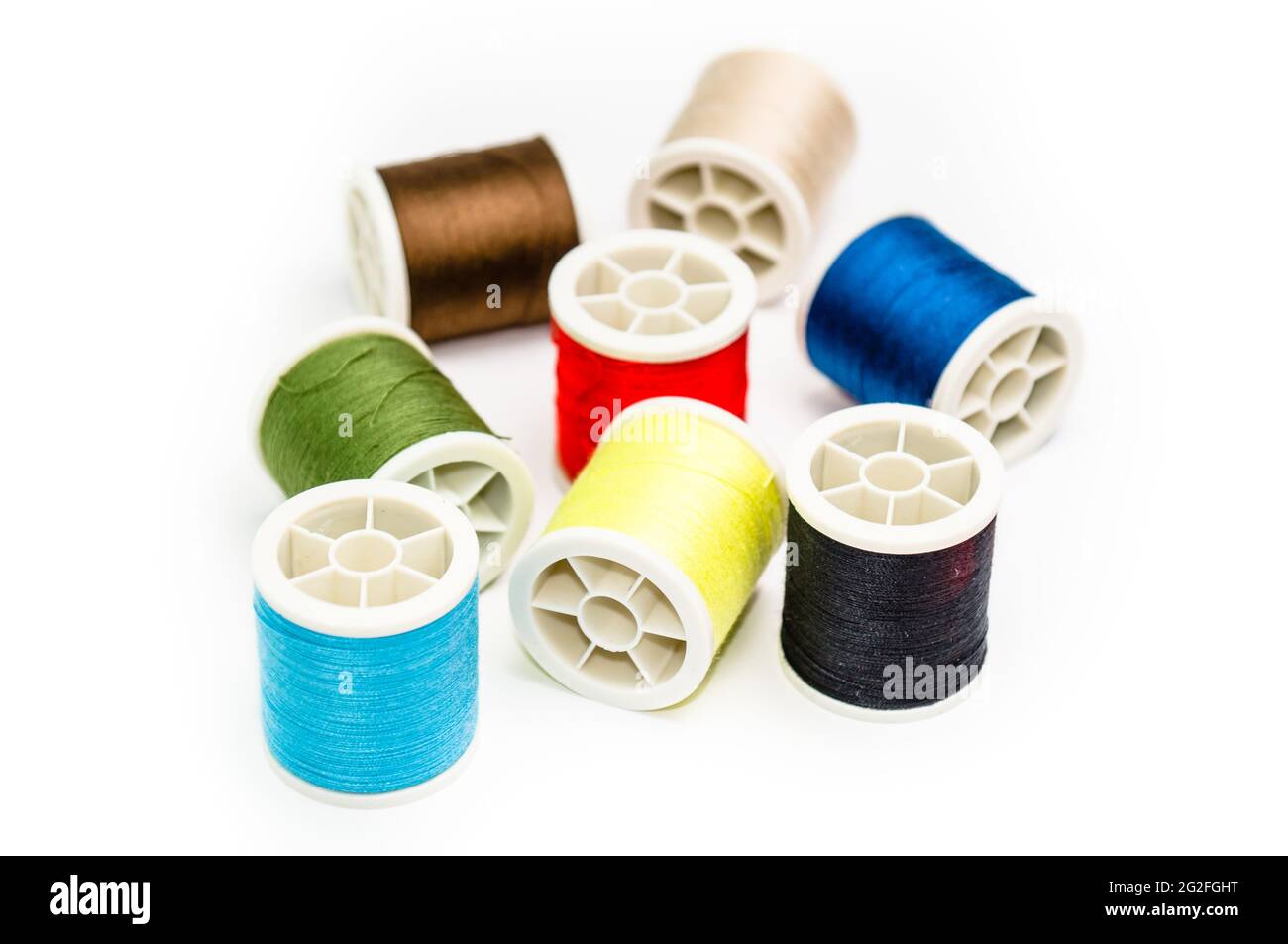 Colorful sewing threads isolated on a white background Stock Photo - Alamy