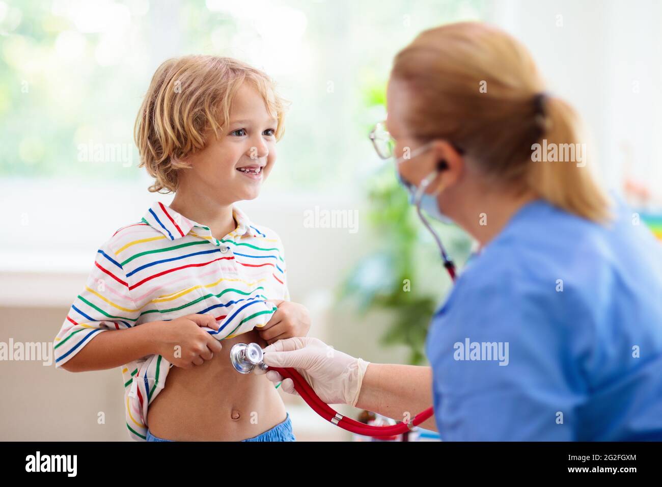 Doctor examining stomach kid hi-res stock photography and images - Alamy