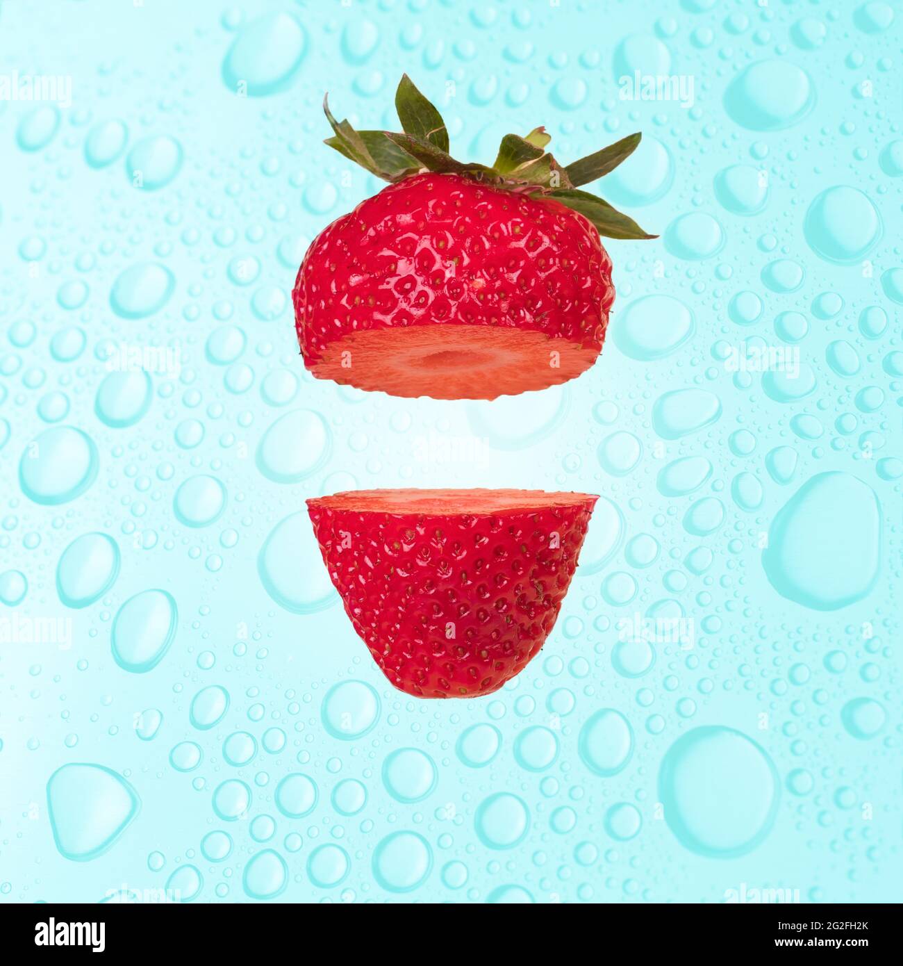 Floating levitating ripe strawberry on a wet blue background with water ...