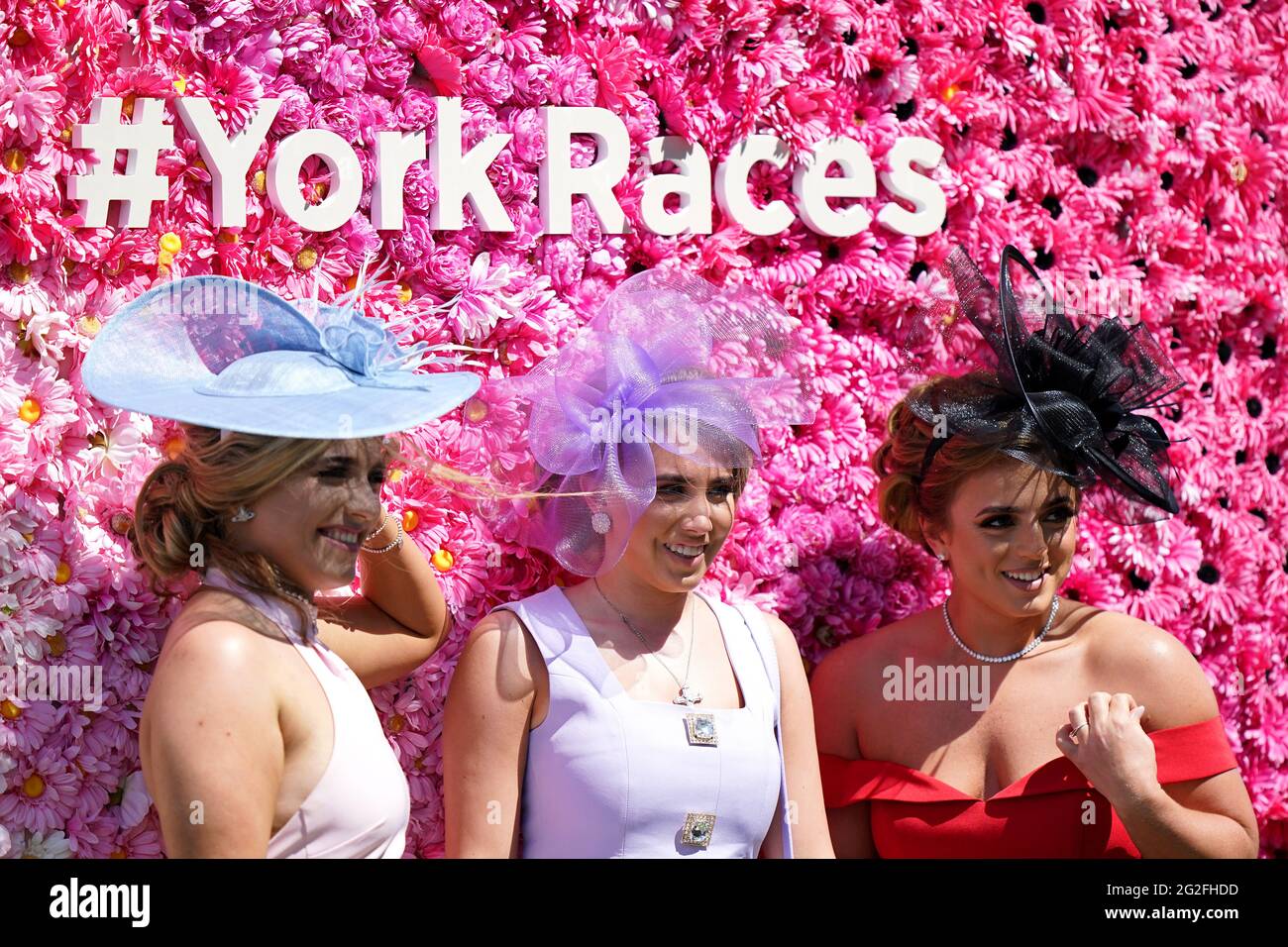 Racegoers pose for photographs at York racecourse. Picture date: Friday ...