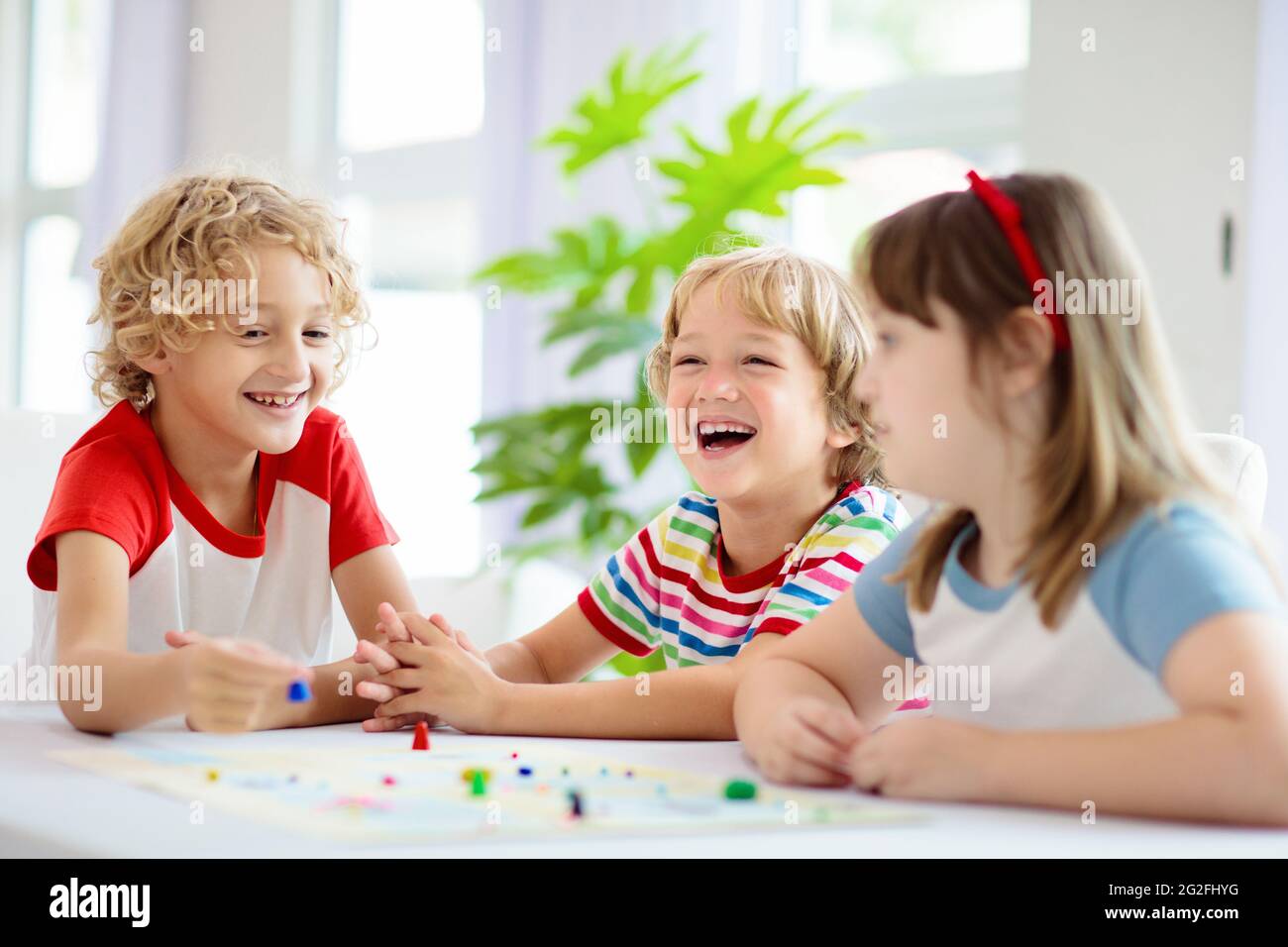Family playing board game at home. Kids play strategic game. Little boy ...