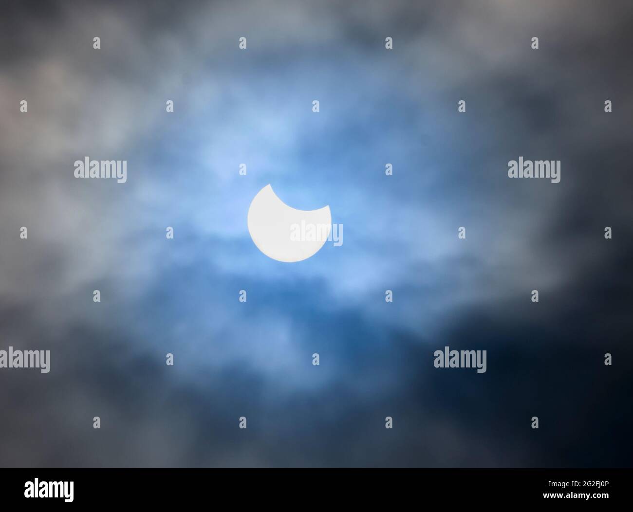Partial solar eclipse as seen in Glasgow Scotland on 10/06/2021 with ...