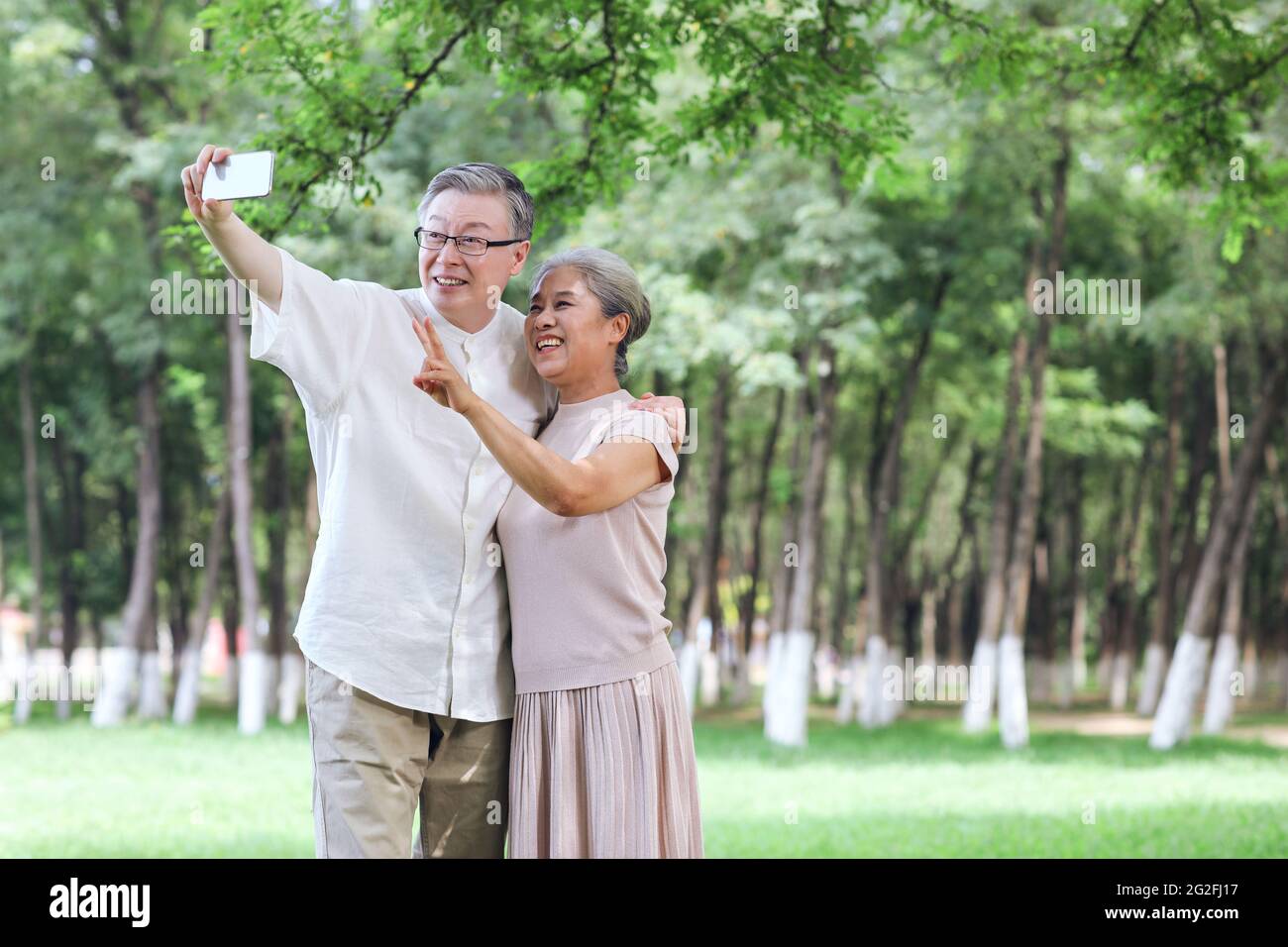 Happy old couple take selfie with mobile phone in park high quality ...