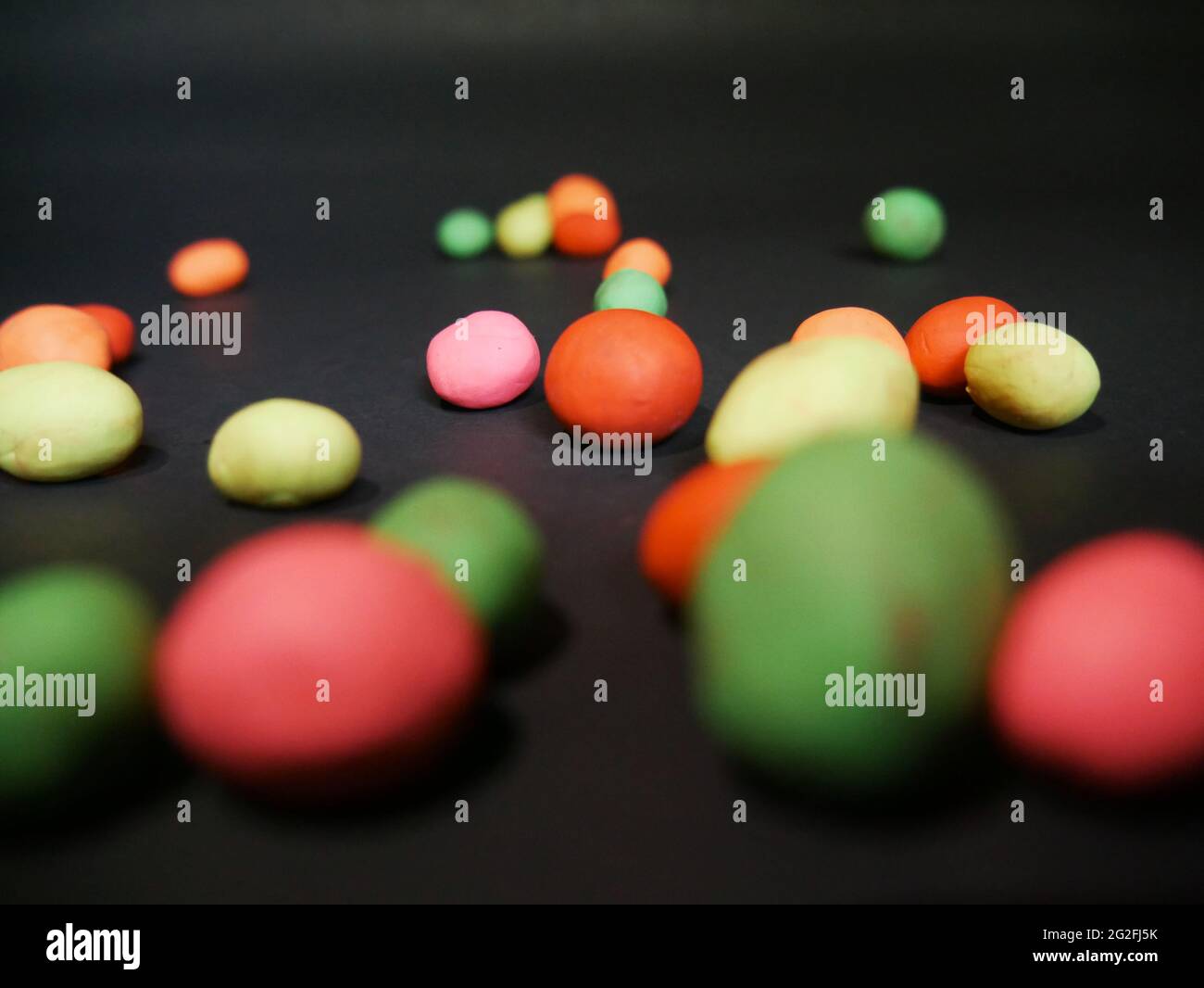 Colorful clay balls presented on dark surface commercial view Stock ...