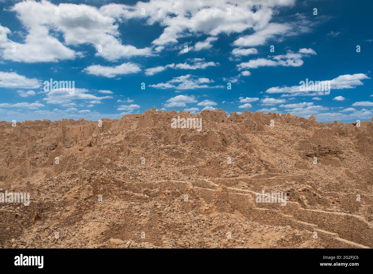 The ruins of the unesco world heritage site of Ouadane under blue sky ...