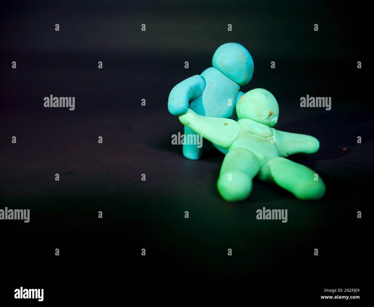 Two clay soft toys fighting on black background Stock Photo - Alamy