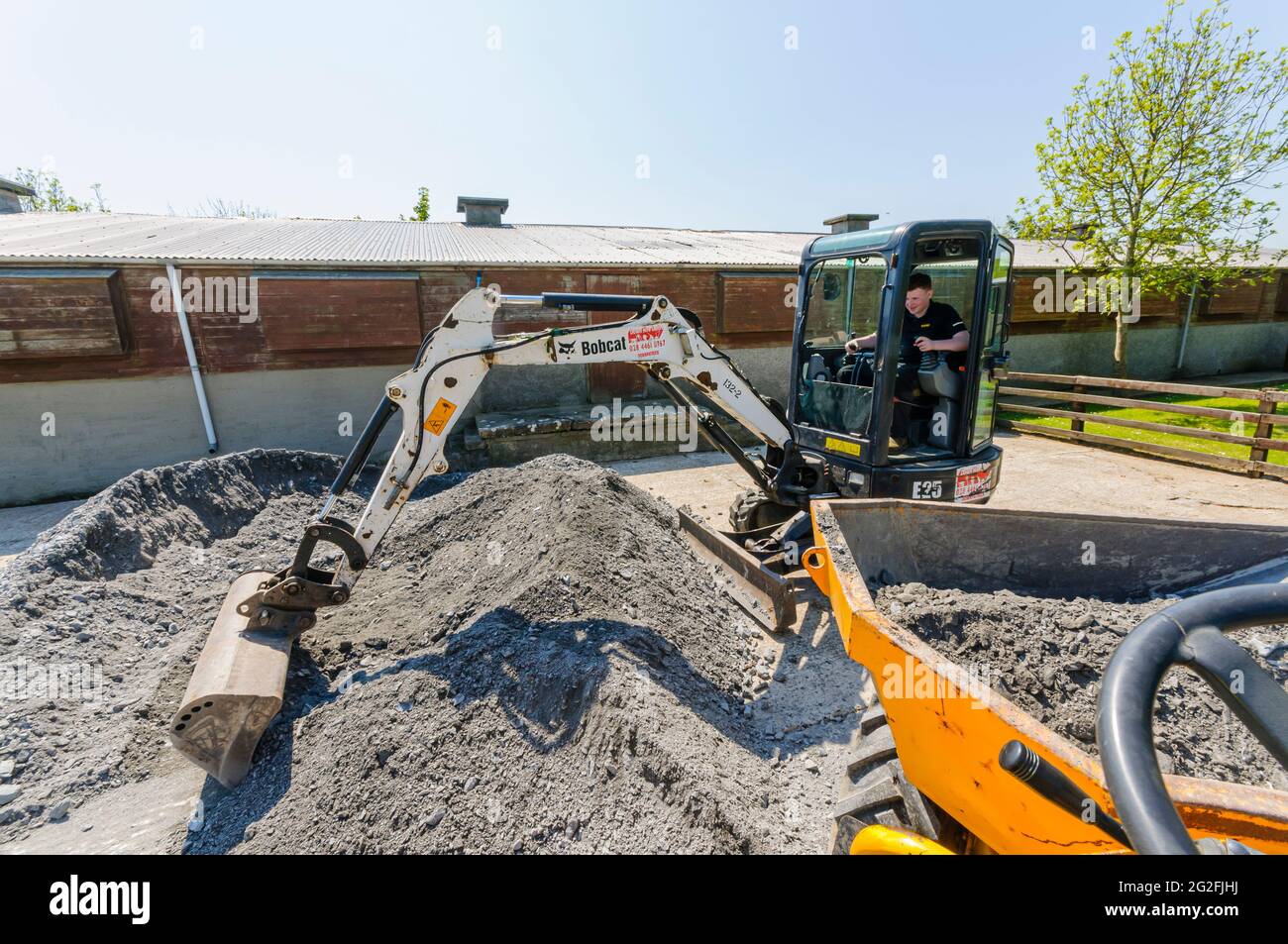 Bobcat E25 mini-digger excavator loads crushed blinding aggregate ...