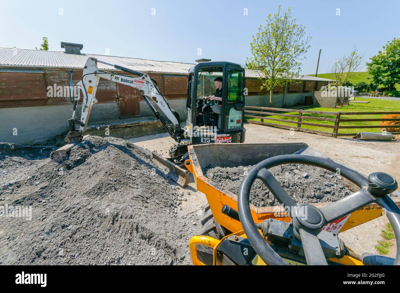 Bobcat E25 mini-digger excavator loads crushed blinding aggregate ...