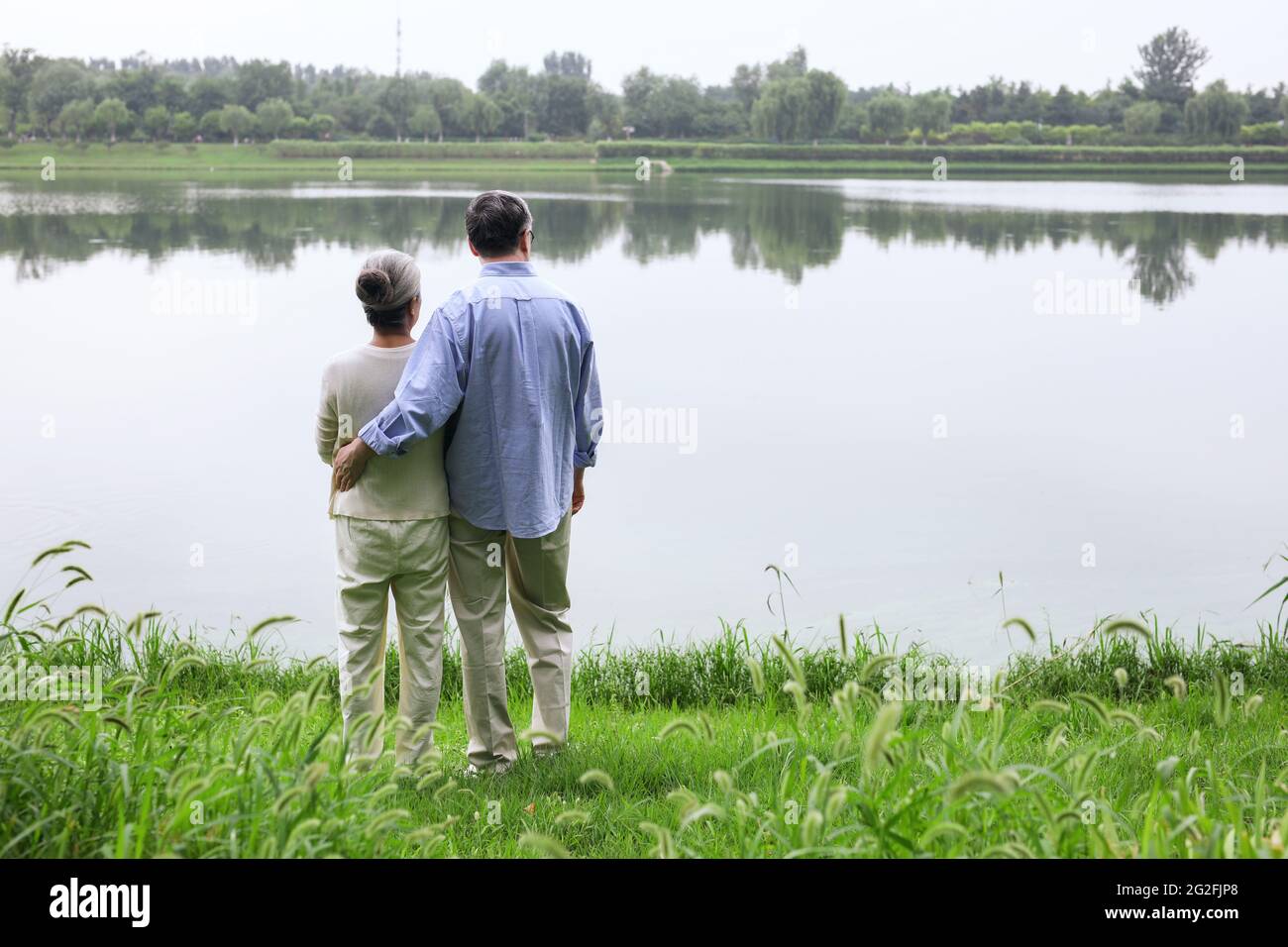 Happy old couple watching the scenery by the lake high quality photo ...