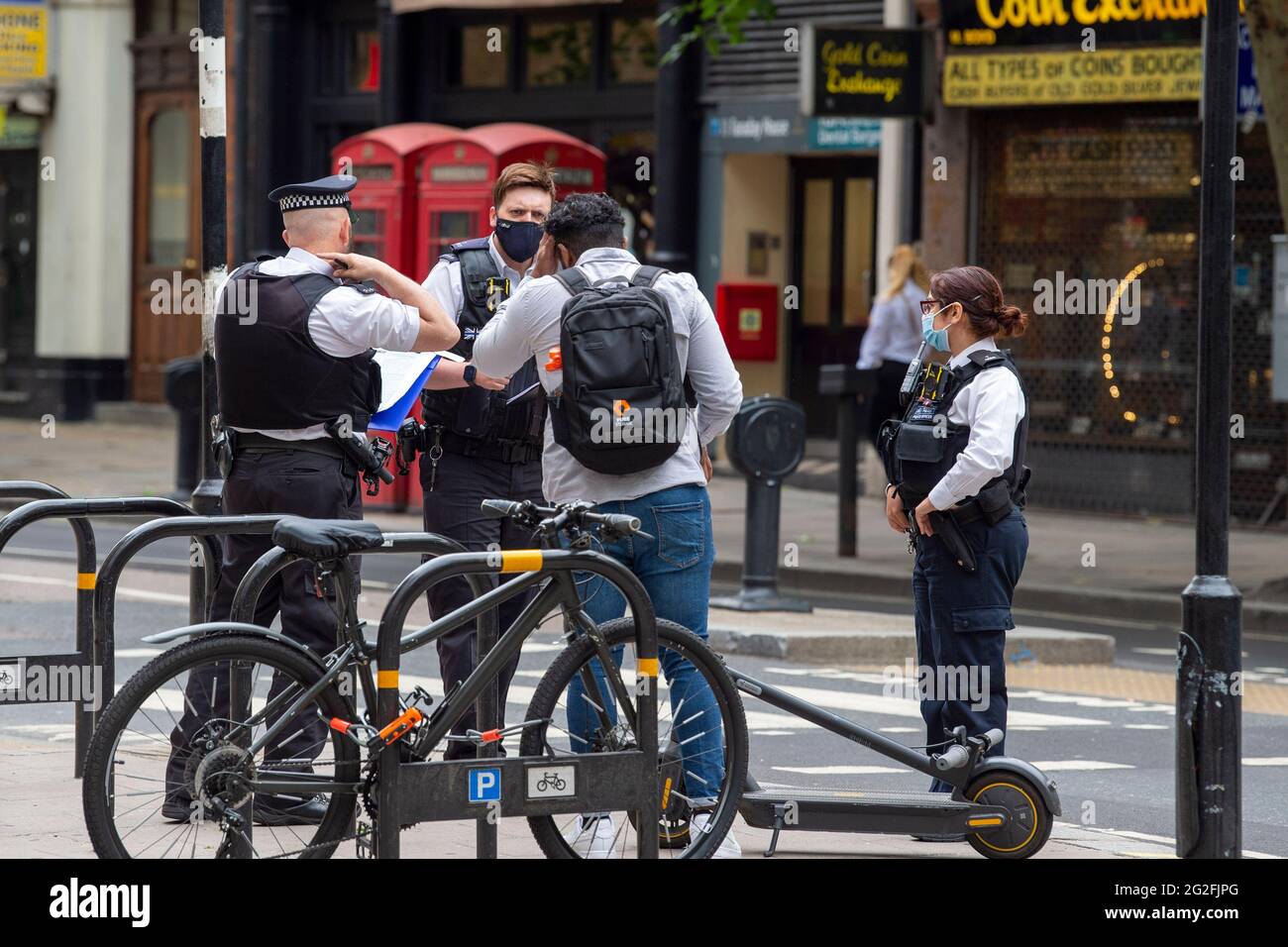 London, UK. 11th June, 2021. Police officers speak to an E-Scooter ...