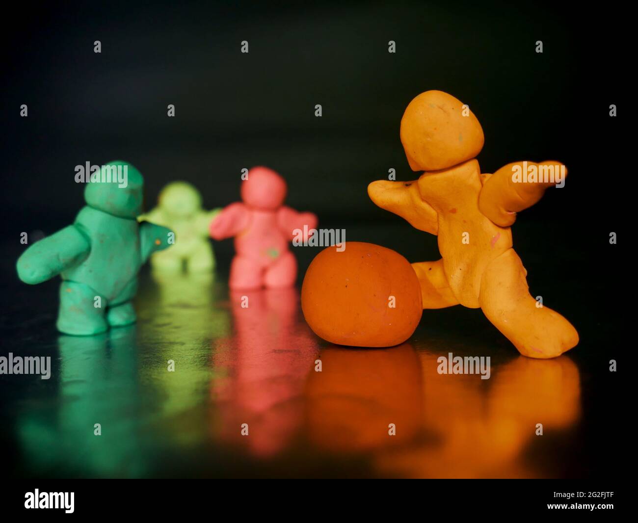 Clay man playing football together focused with single soft toy Stock ...