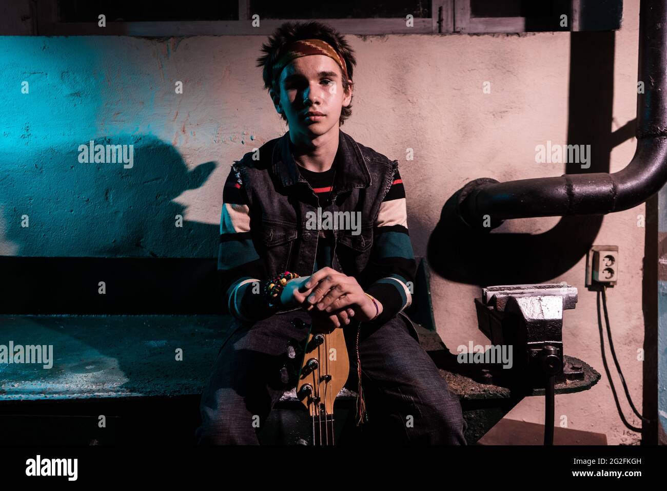 portrait of a musician. Handsome young man with musical instruments ...