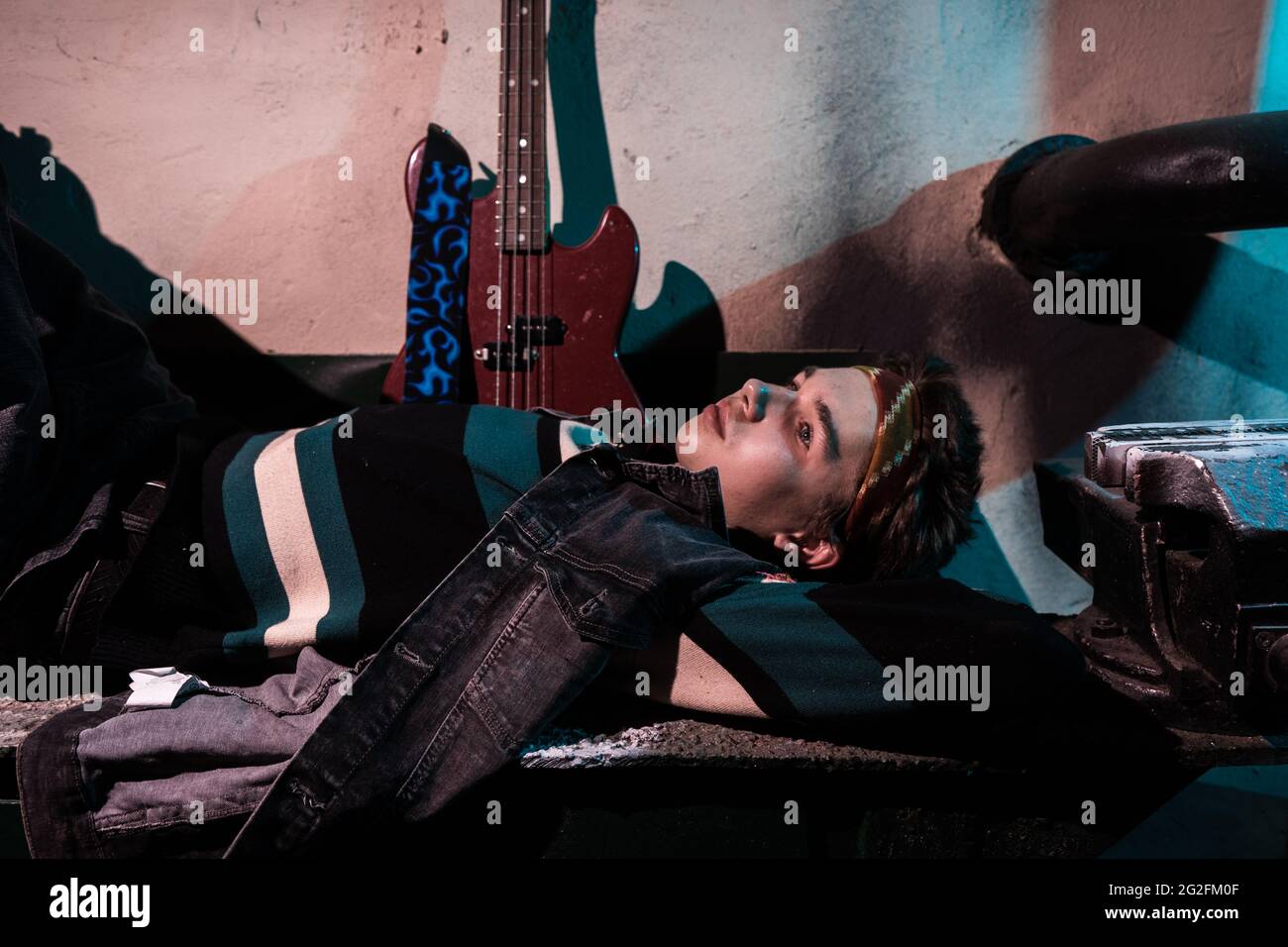 portrait of a musician. Handsome young man with musical instruments ...