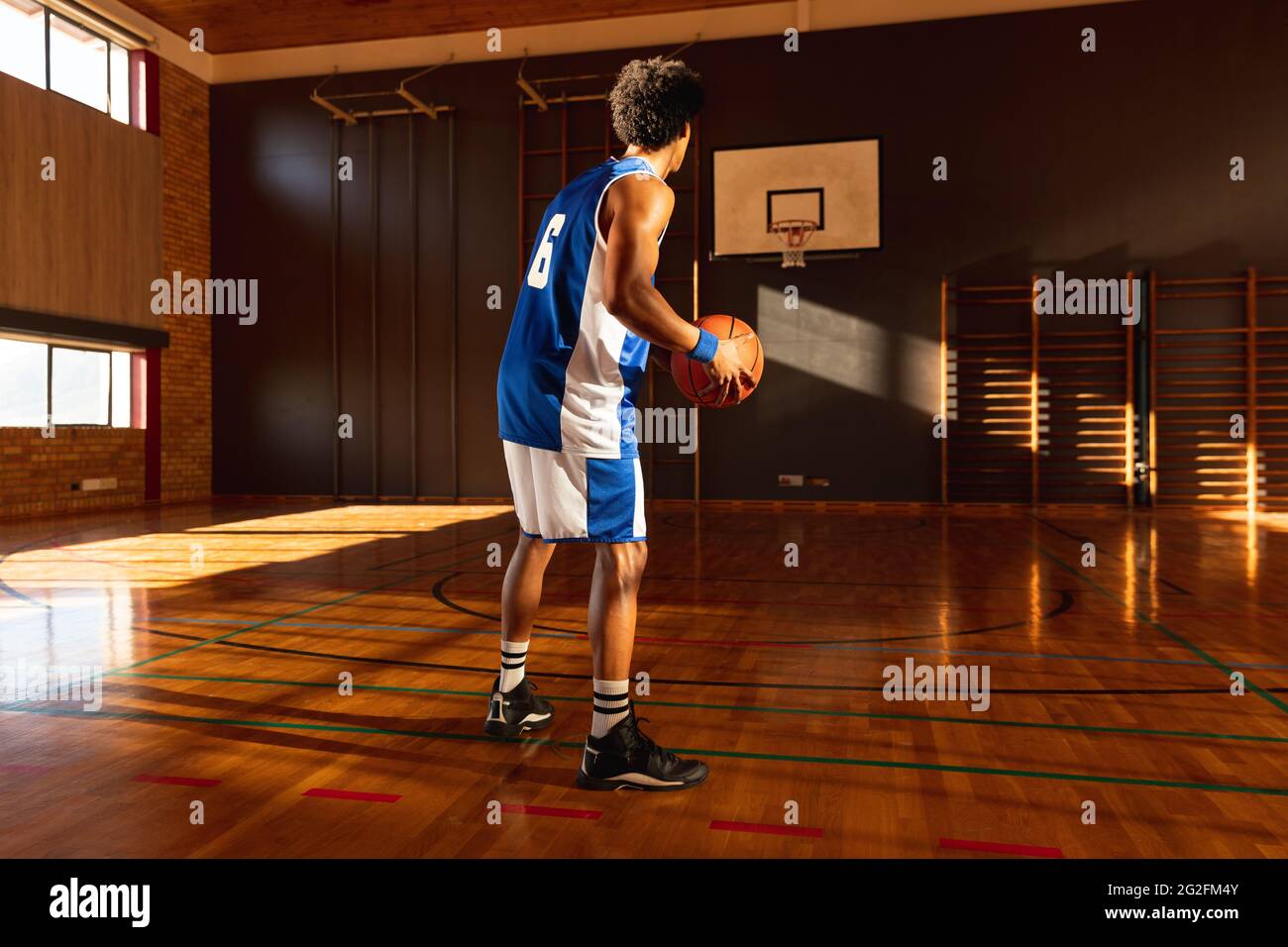 Mixed race male basketball player practicing shooting with ball Stock ...