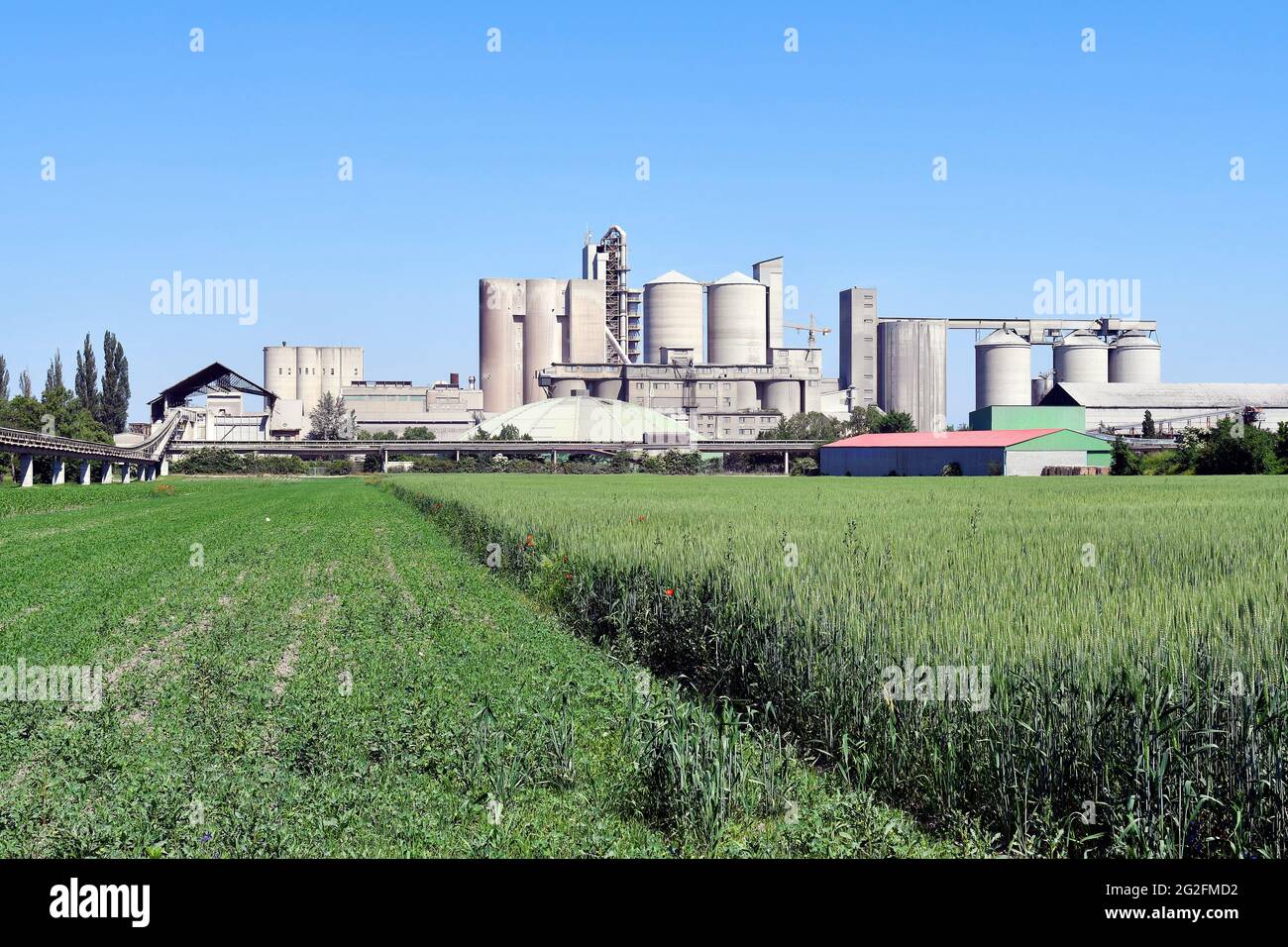 Austria, cement factory with conveyor belt and farmland in Lower ...