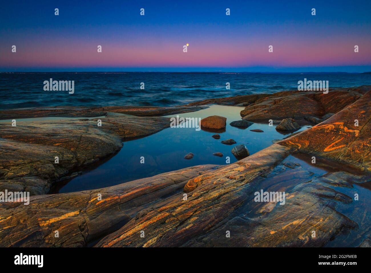 Early winter morning with moon and colorful skies by the Oslofjord at ...
