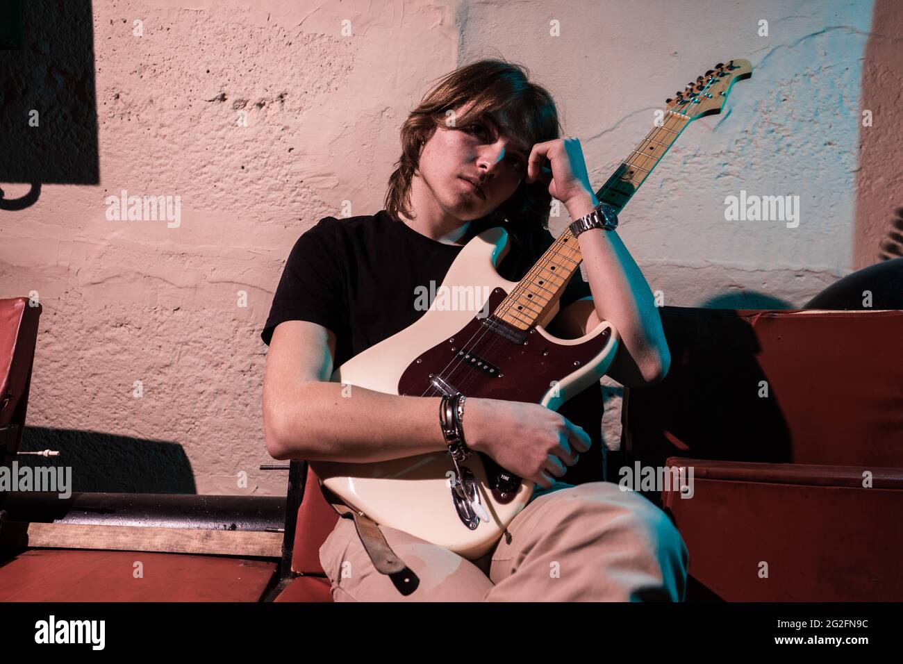 portrait of a musician. Handsome young man with musical instruments ...