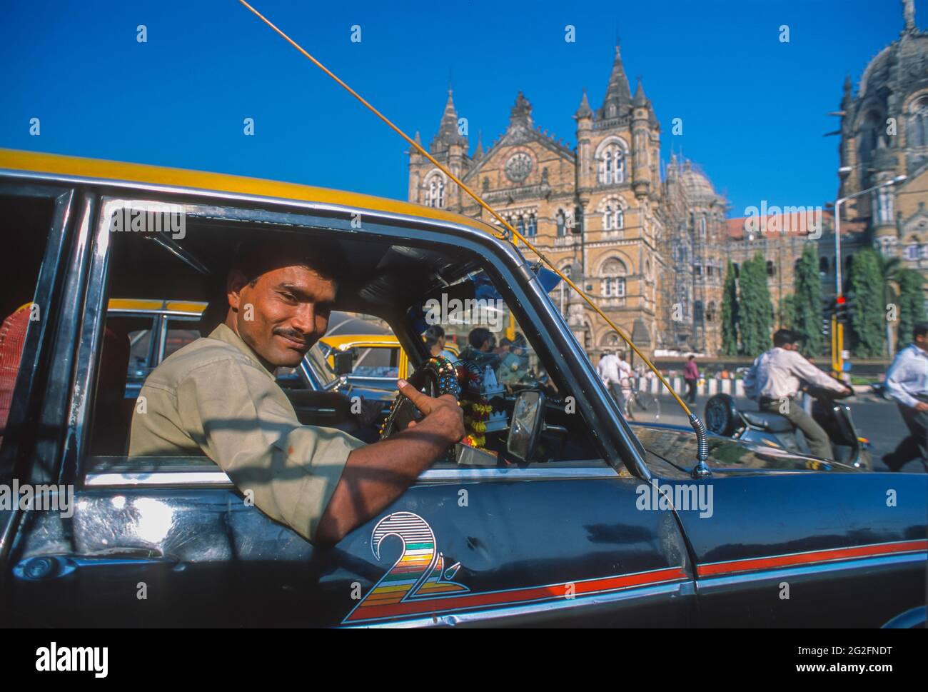 MUMBAI, INDIA - Taxi driver in taxi in front of Victoria Train Station ...