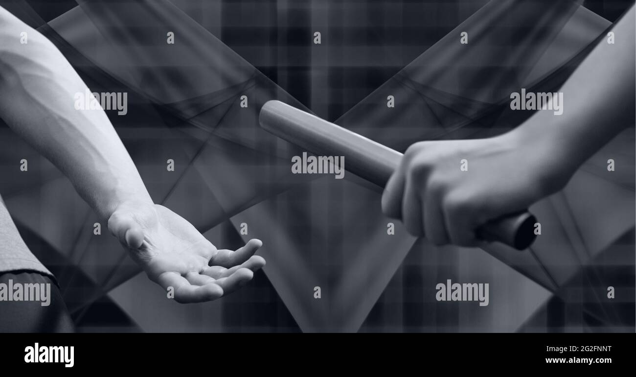 Black and white image of close up of hand passing a baton against ...