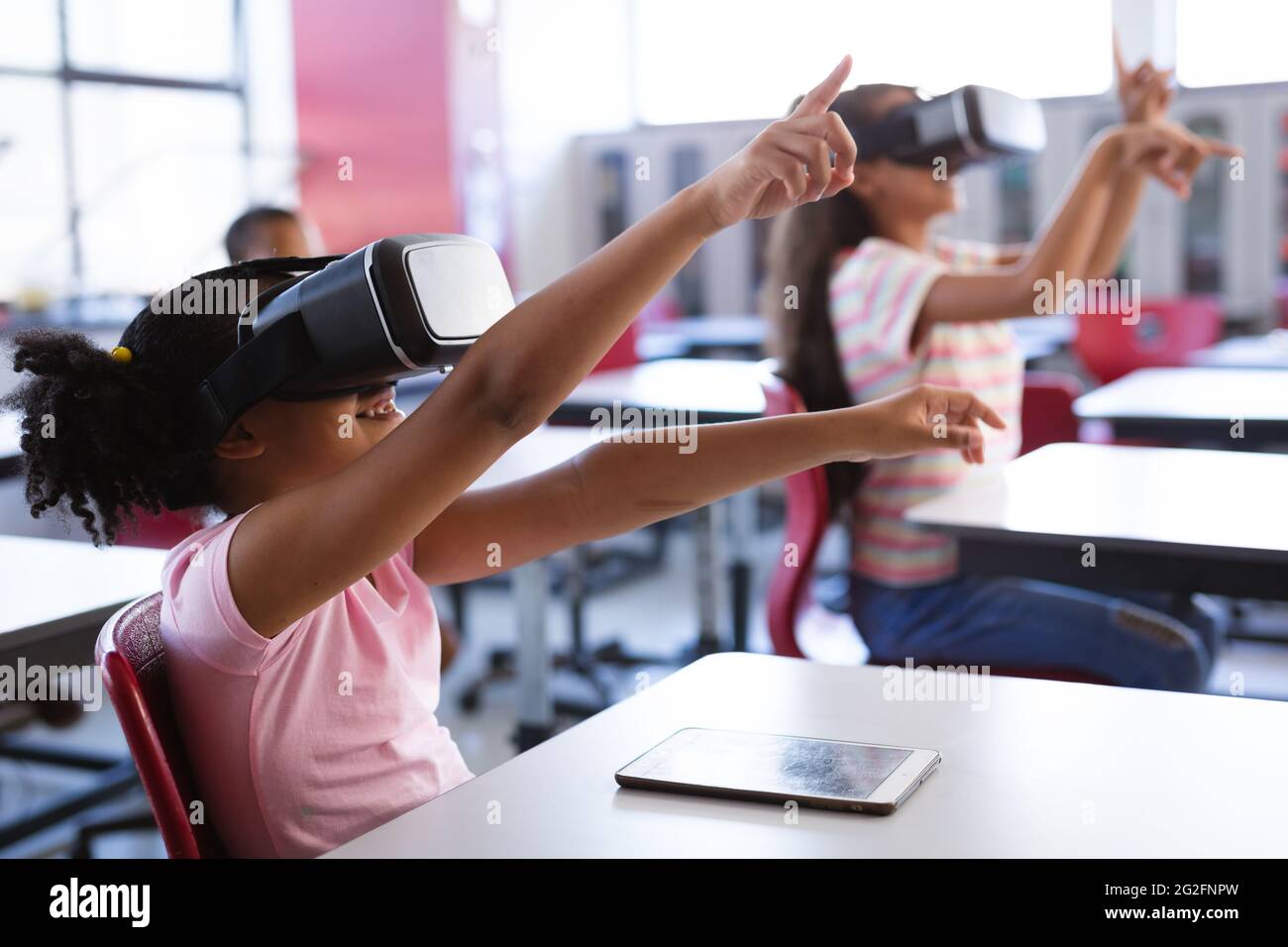 African american girl wearing vr headset gesturing while sitting on her ...