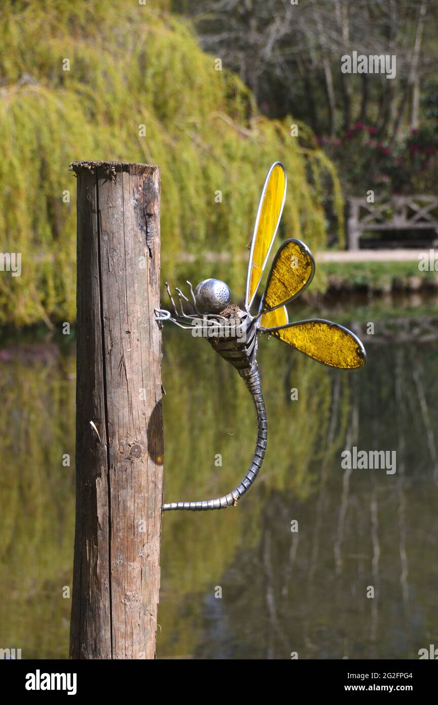 Yellow Metal Dragonfly Sculpture on a Post by the Magnolia Lake at The ...