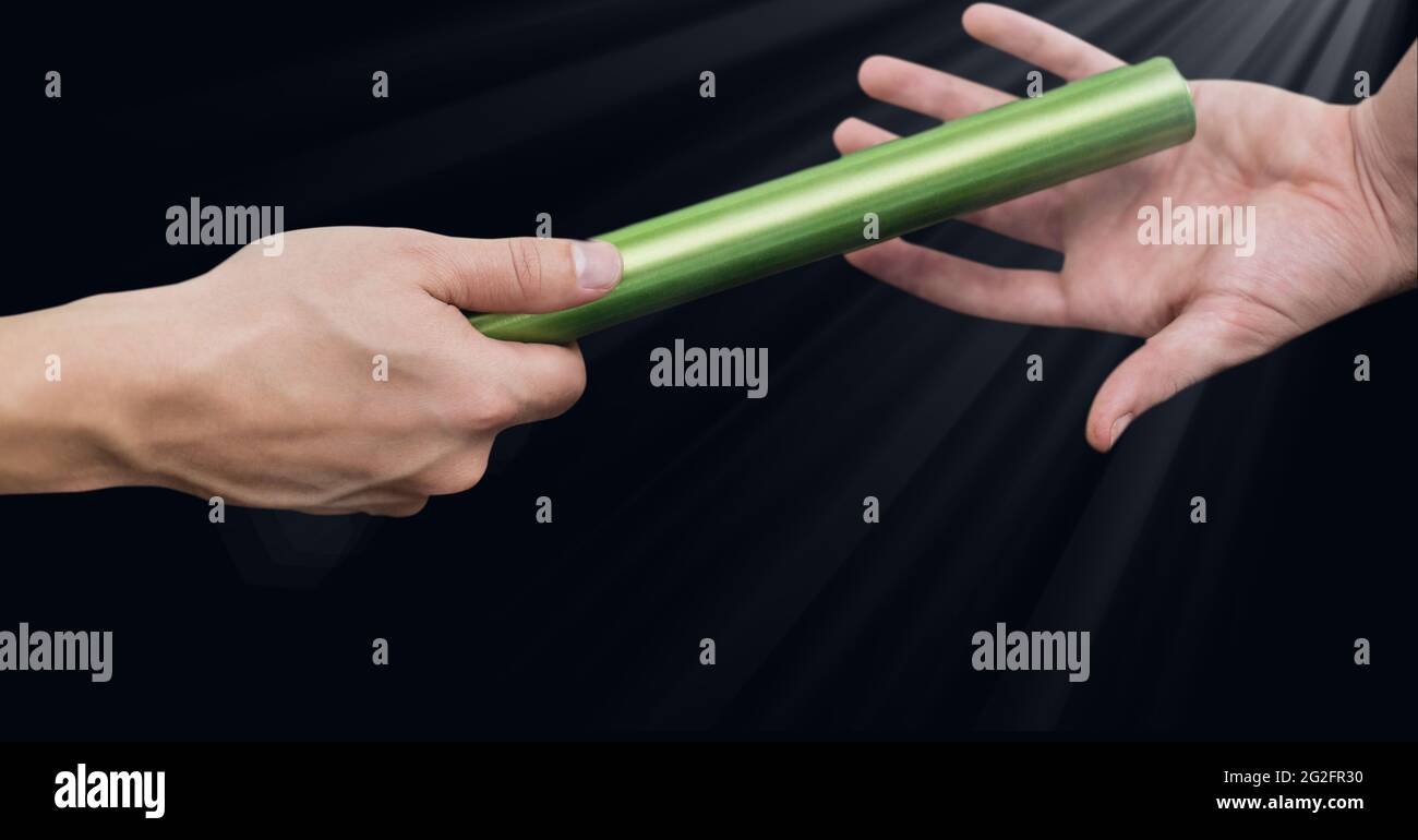 Composition of caucasian athletes passing green relay baton with ...