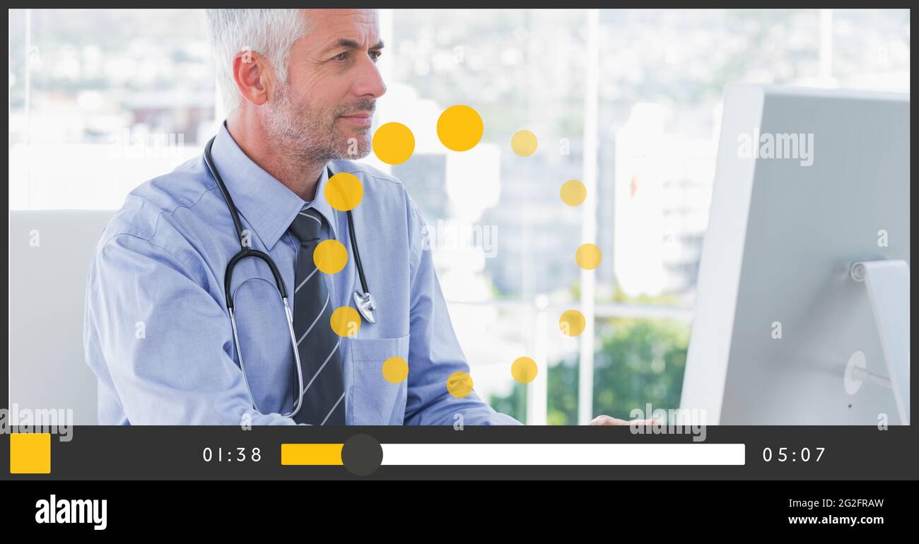 Composition of male doctor using computer on video playback interface ...