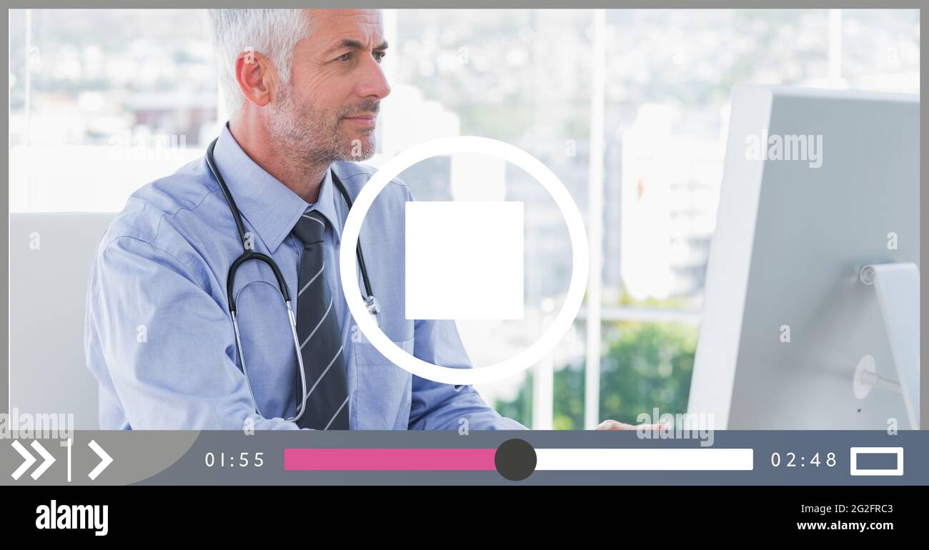 Composition of male doctor using computer on video playback interface ...