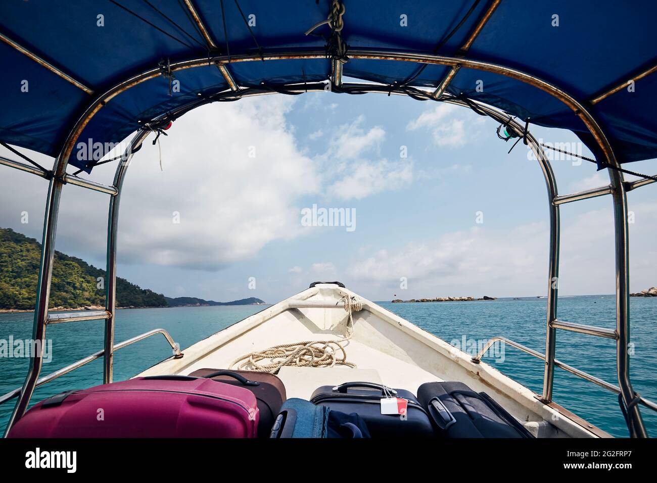 Suitcases on board motor boat floating on sea to tropical island Stock ...