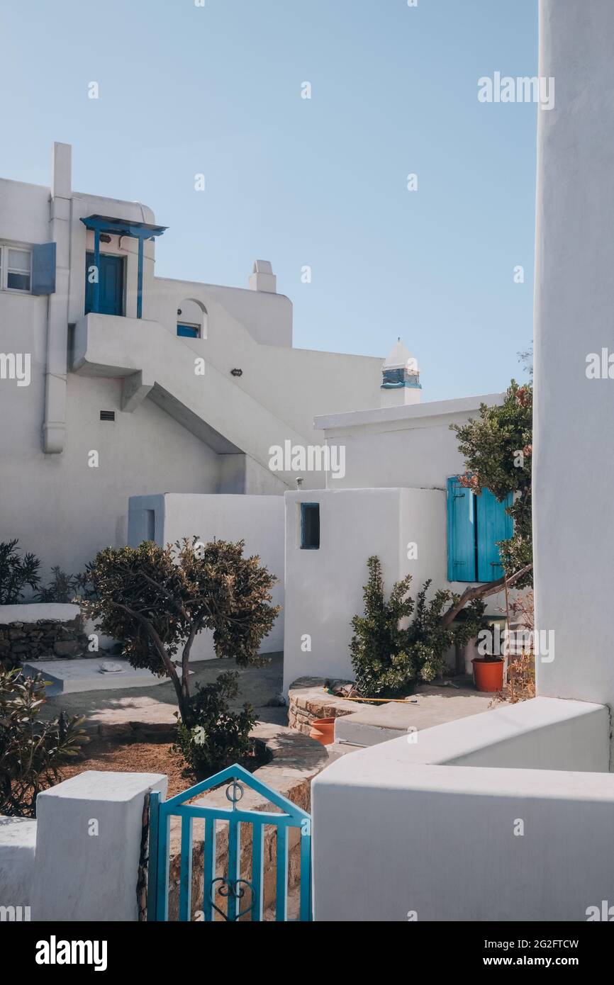 Exterior of a typical Mykonian white house with blue fence, door and ...