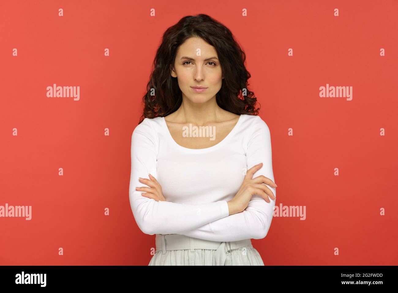 Angry grumpy female hold hands folded at studio wall. Dissatisfied ...