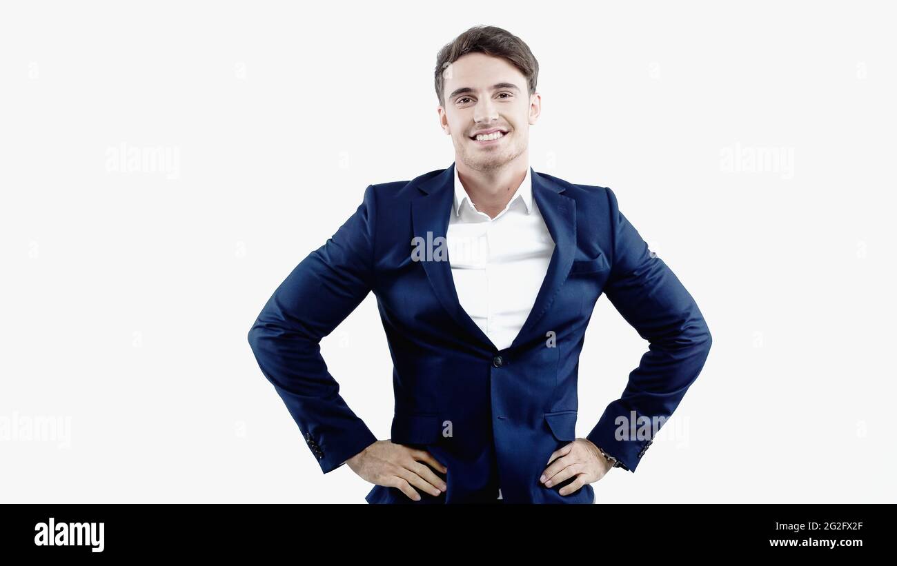 Businessman with hands on hips smiling isolated on white Stock Photo ...