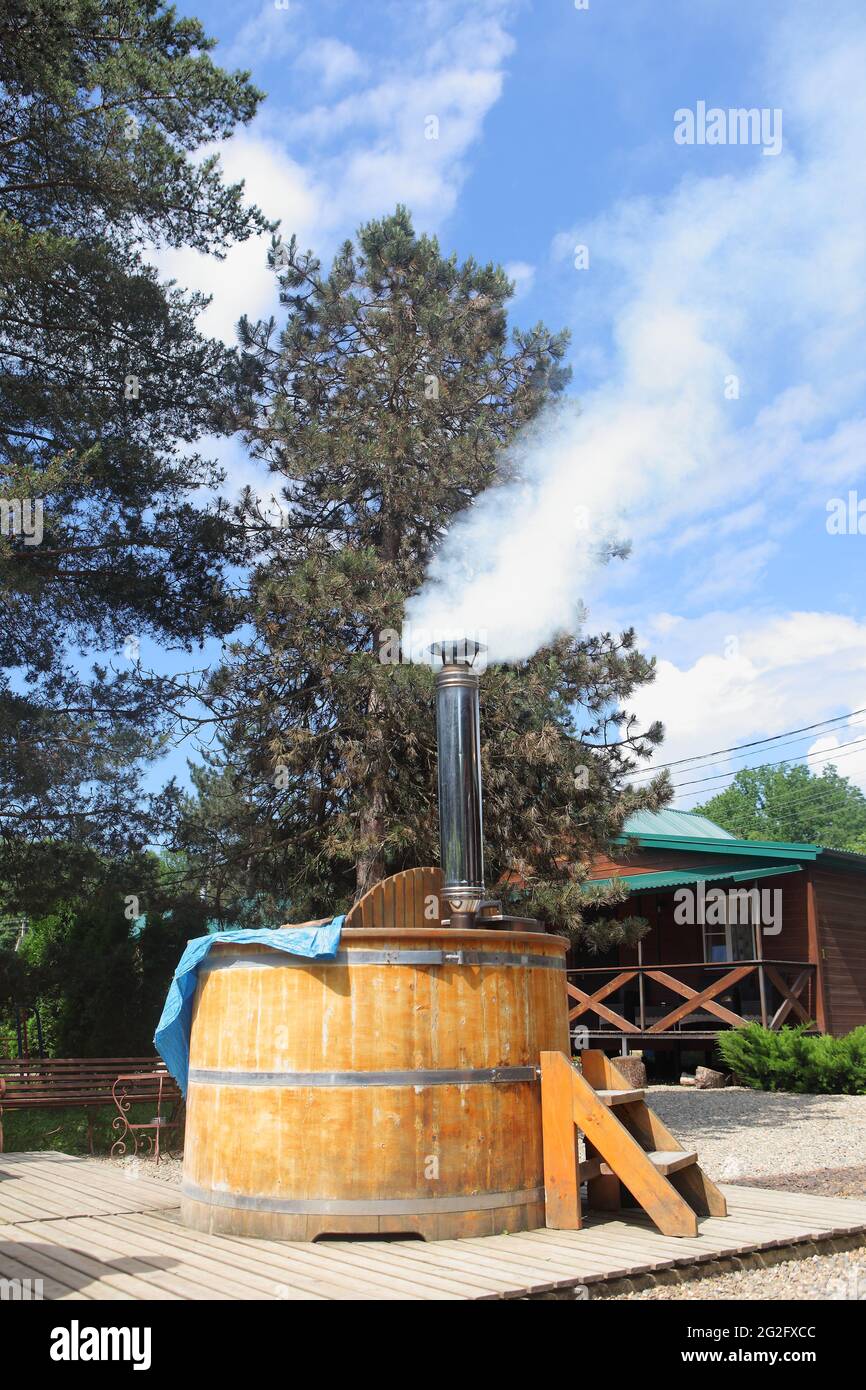 Wooden phyto tub with water with herbal decoction Stock Photo - Alamy