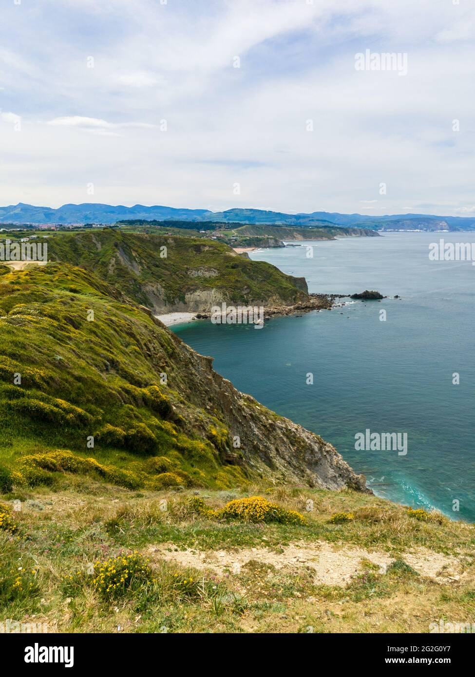 Natural view of grass field cliff near a coast under a cloudy sky Stock ...