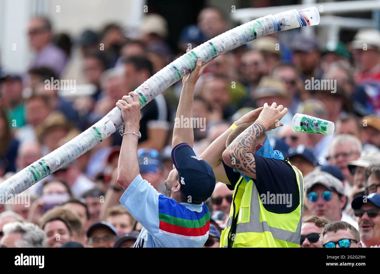 Fans in the stands make a beer snake out of empty plastic pint cups ...