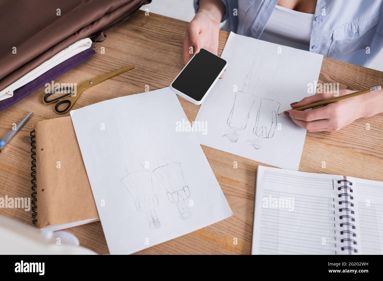 Woman seamstress drawing clothing sketch hi-res stock photography and ...