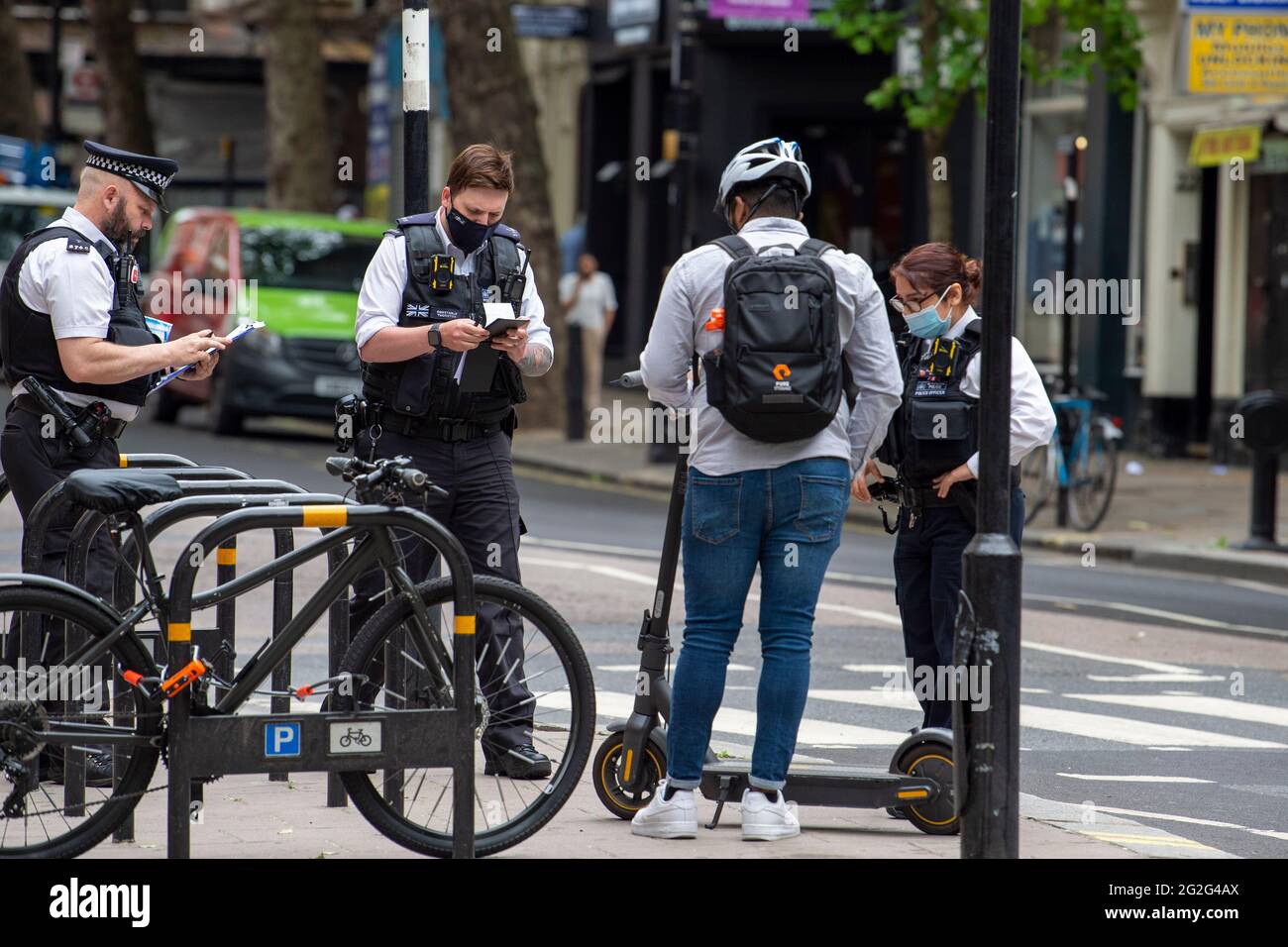 A police officer writes in his notebook after having stopped an E ...
