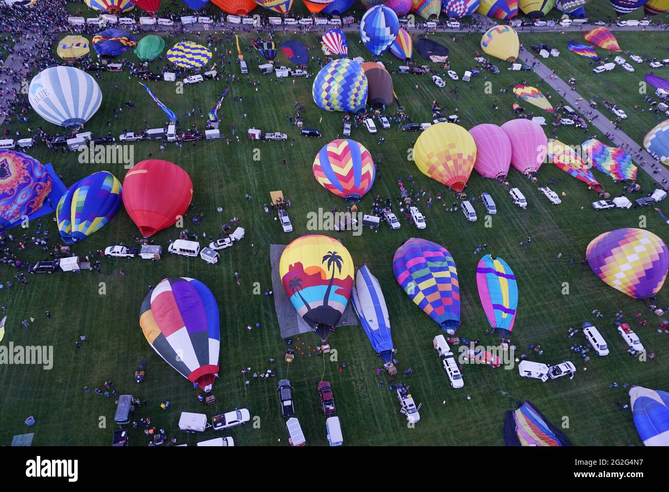 Aerial view of hot air balloons on the field, getting ready for ...