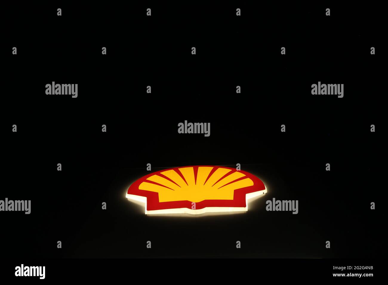 Illuminated Shell logo garage sign against a black sky background, sign ...